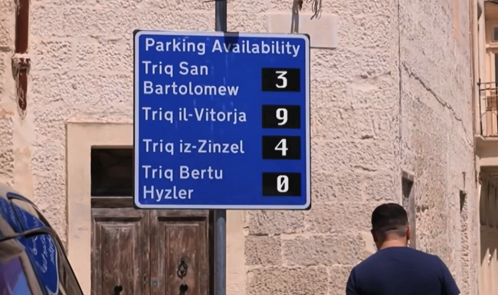 Signs indicate number of remaining parking spaces to avoid driving ...