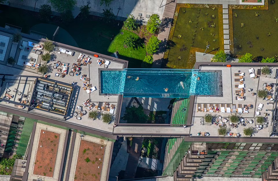 WATCH: Residents swim in glass pool resting between two tall buildings ...